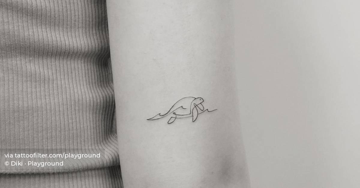 Abstract turtle tattoo located on the tricep, fine line