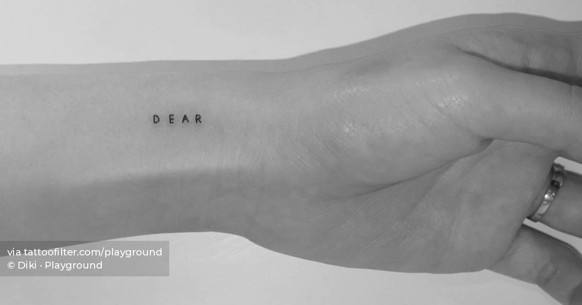 Tattoo of the word "dear" located on the wrist.