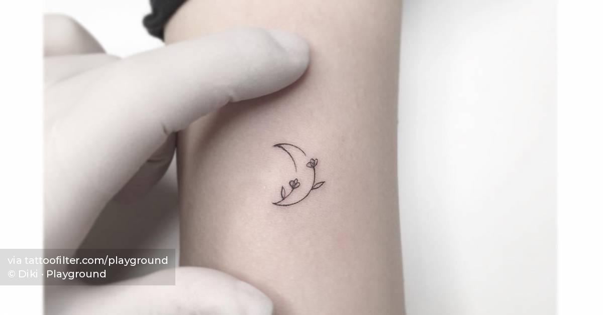 Fine line flower moon tattoo located on the inner arm.