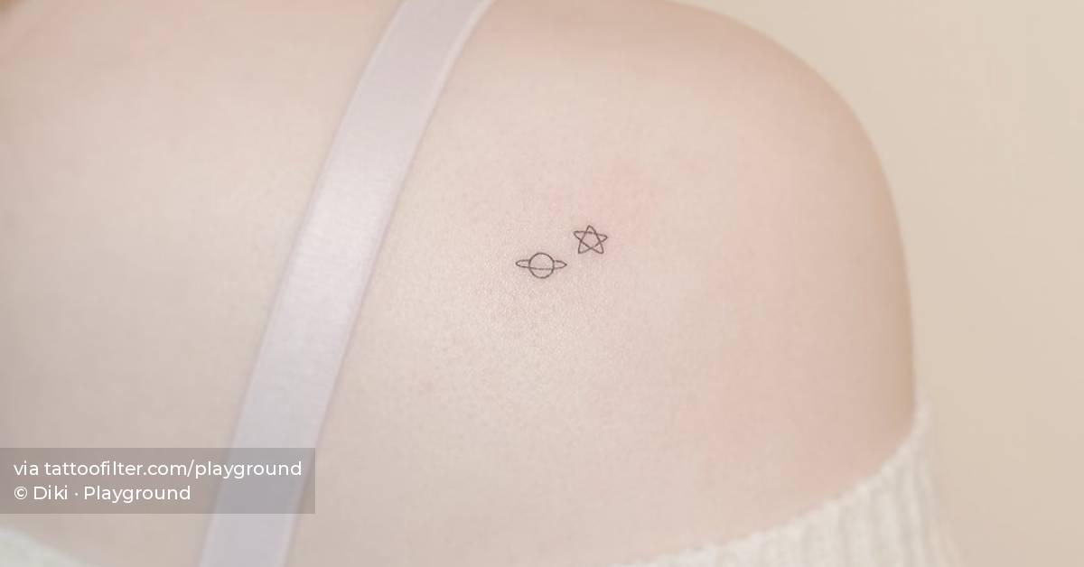 Fine line Saturn and star tattoo located on the