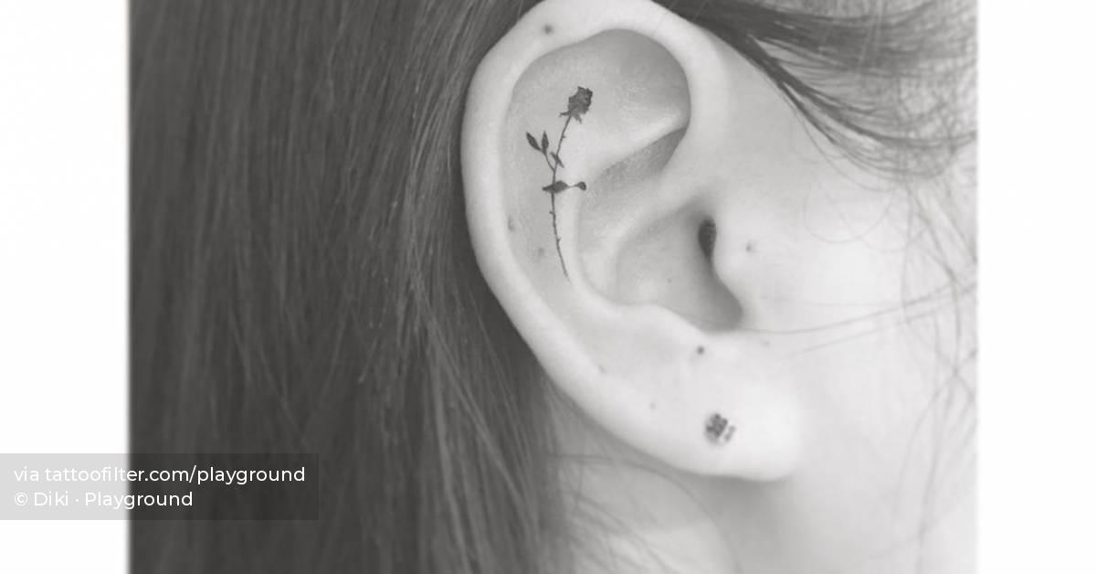 Minimalistic black rose tattoo done on the ear.