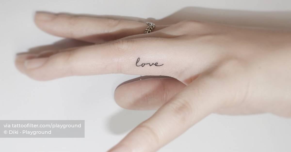 Tattoo of the word "love" handwritten on the finger.