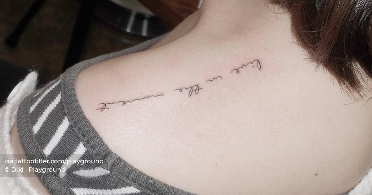 Tattoo that says "live in the moment" handwritten on