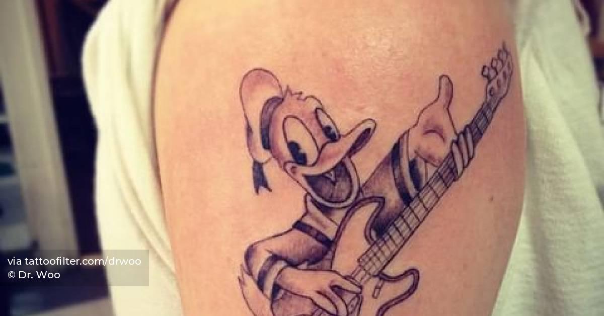 Bassist Donald Duck tattooed on the upper arm.