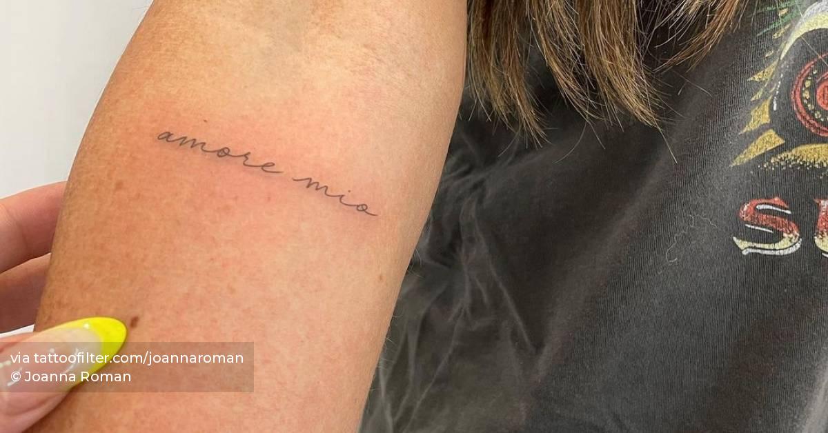 Tattoo that says "amore mio" handwritten on the inner