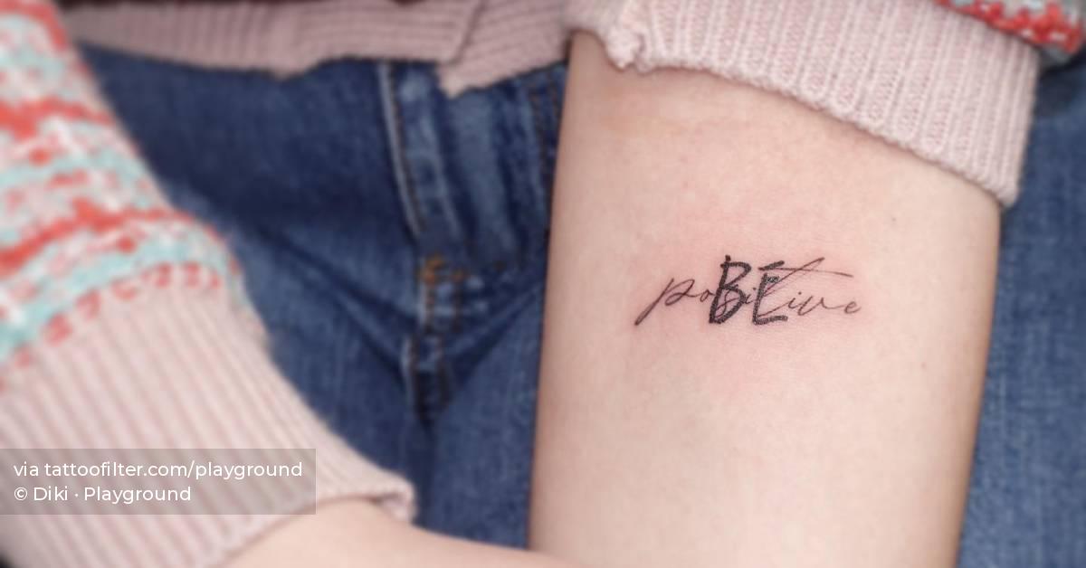 "Be positive" lettering tattoo located on the inner