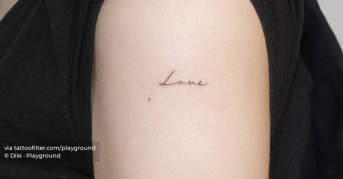 Tattoo of the word "love" handwritten on the upper arm.