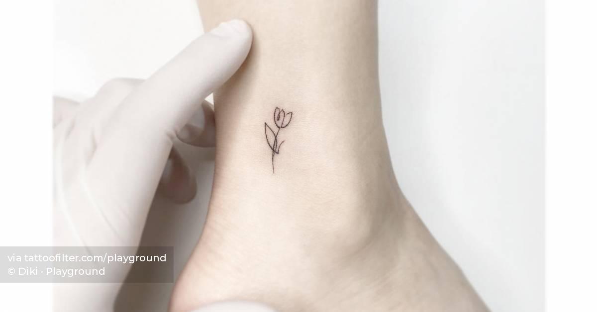 Fine line tulip flower tattoo located on the ankle.