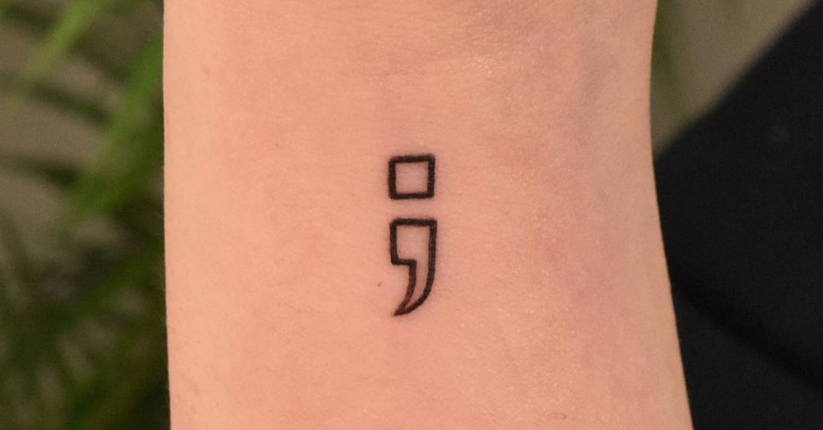 Minimalistic style semicolon tattoo done on the wrist.