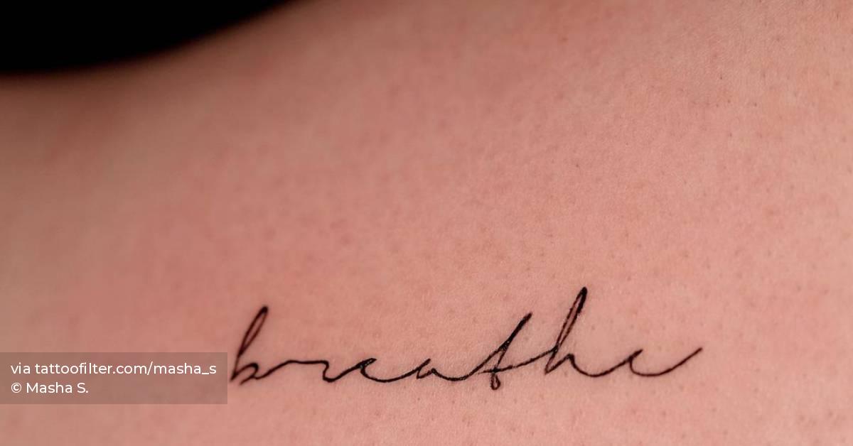 Tattoo of the word "breathe" located on the upper back.