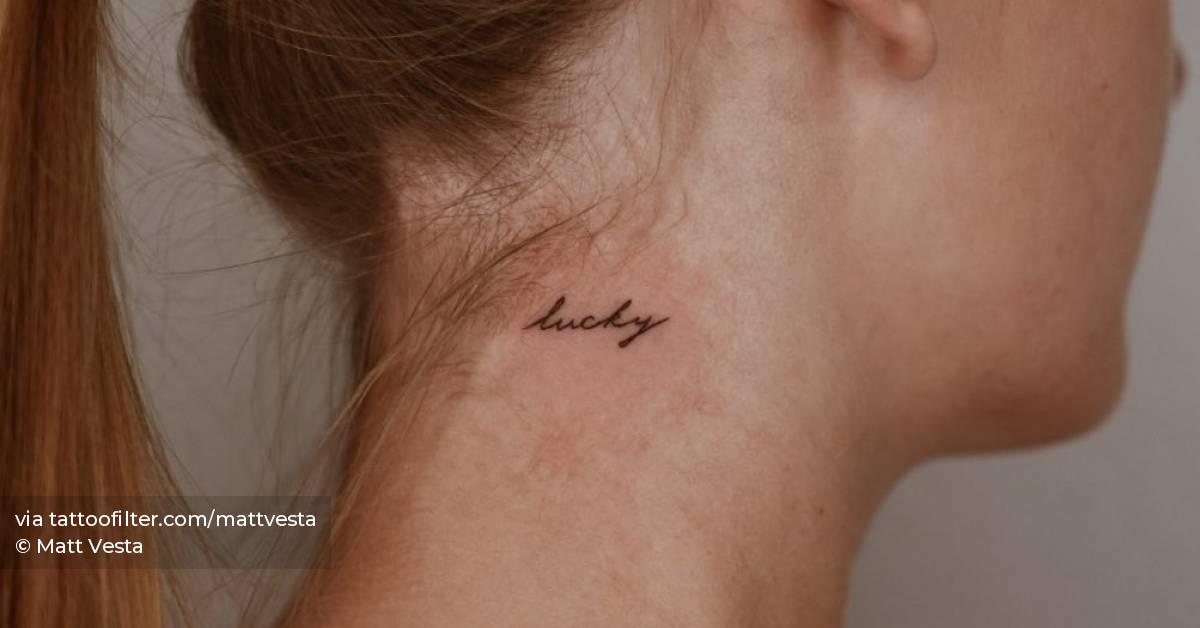 Tattoo of the word "lucky" done on the neck.