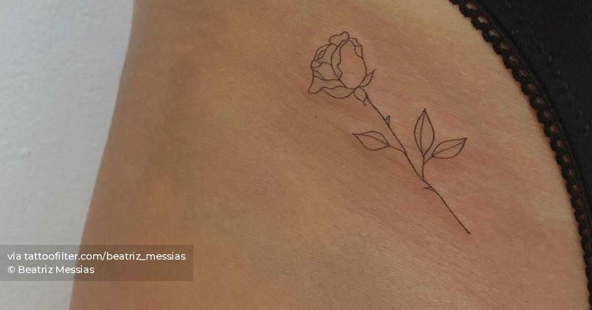 FIne line rose tattoo done on the pelvis, minimalistic