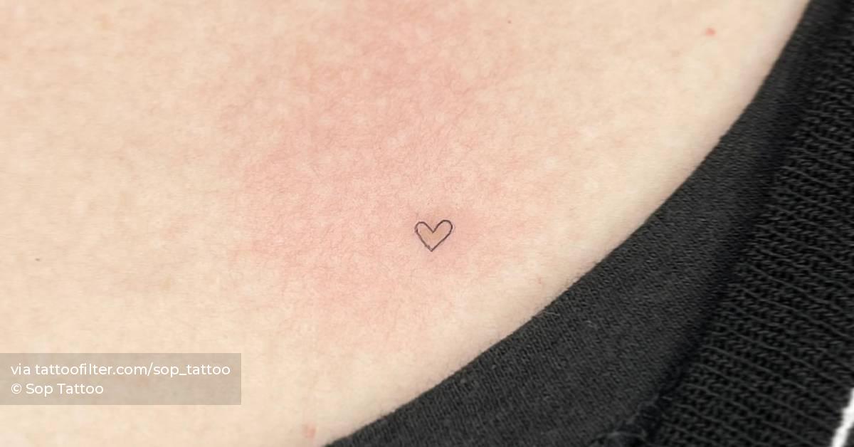 Micro heart tattoo located on the chest, minimalistic