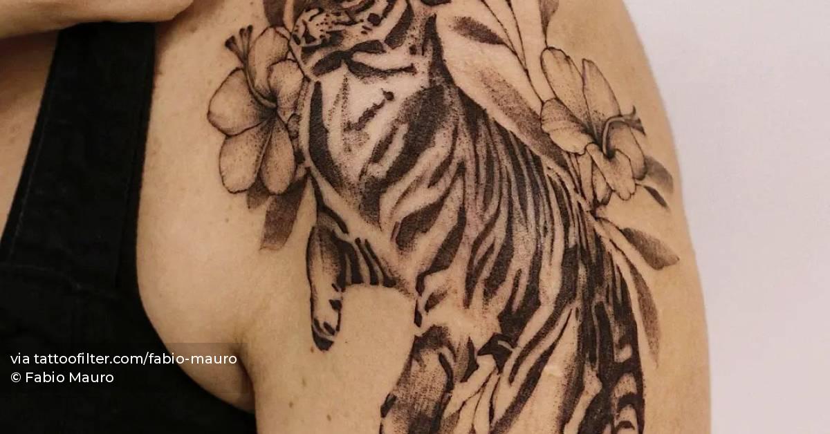 Tiger tattoo located on the upper arm, blackwork style.