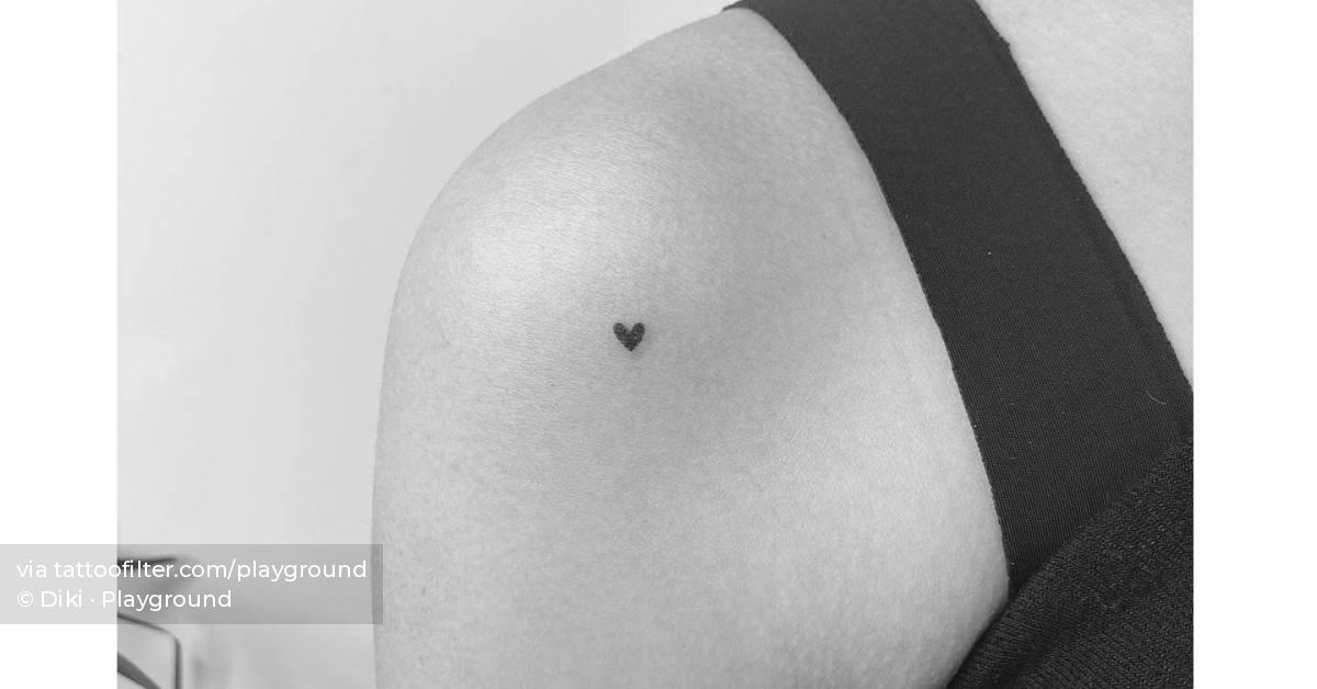 Micro heart tattoo placed on the shoulder, minimalistic