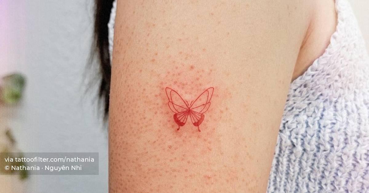 Fine line style red butterfly tattoo done on the upper