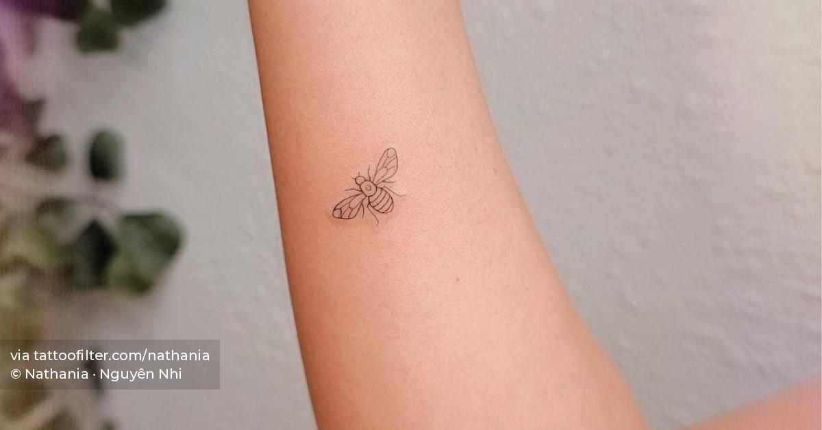 Fine line style bee tattoo located on the inner