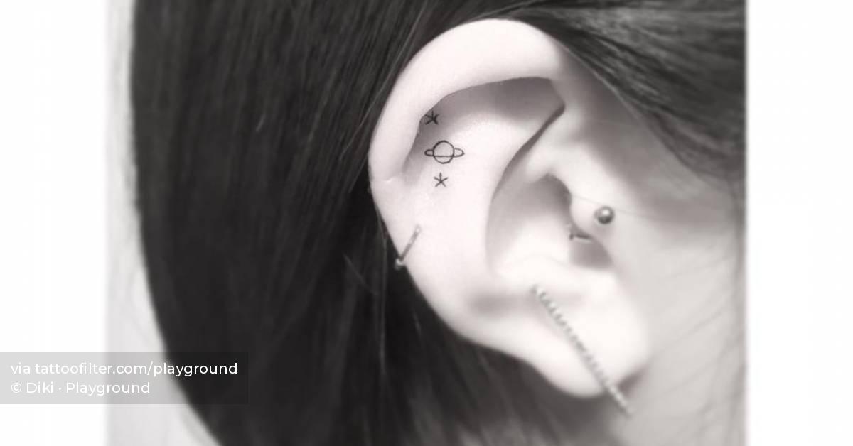 Tiny minimalistic Saturn and stars tattoo located on
