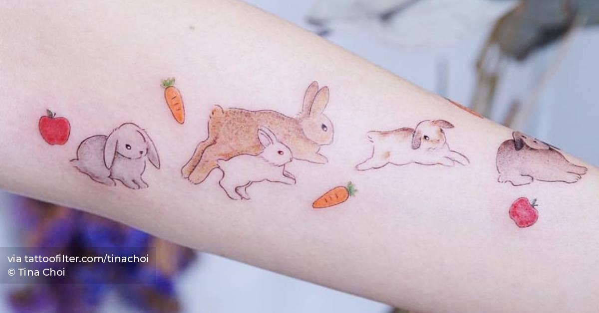 Watercolor rabbits tattoo on the forearm.