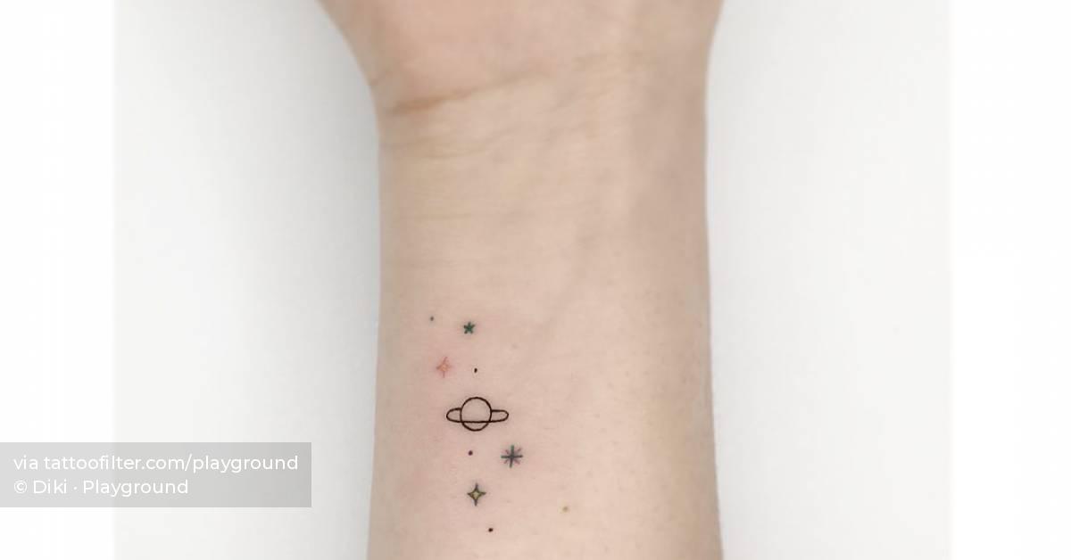 Minimalistic universe tattooed on the wrist.