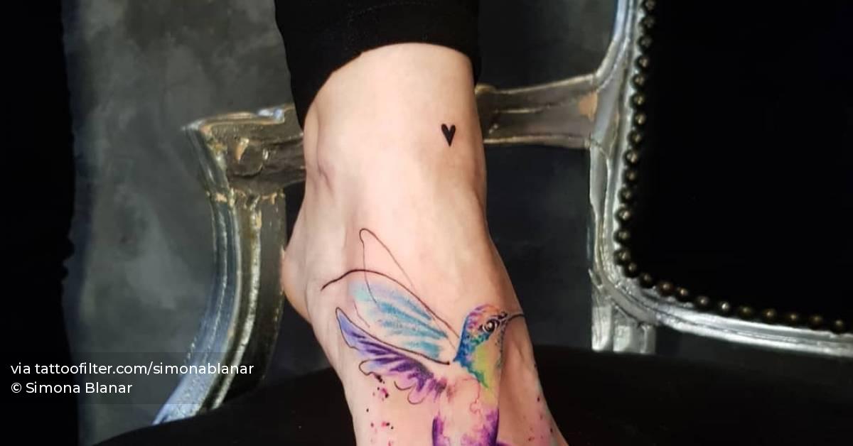 Colorful hummingbird tattoo located on the foot,