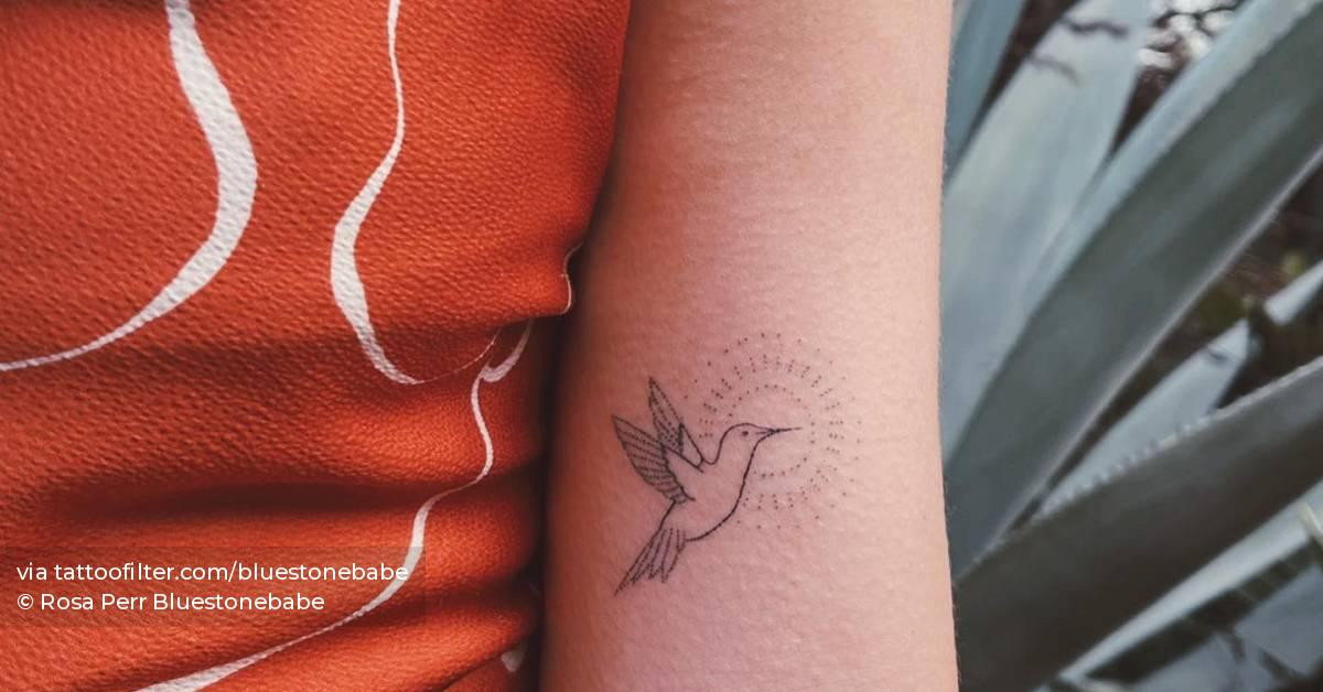 Hand poked hummingbird tattoo located on the inner arm.