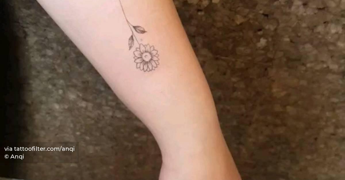 Fine line sunflower tattoo located on the wrist.