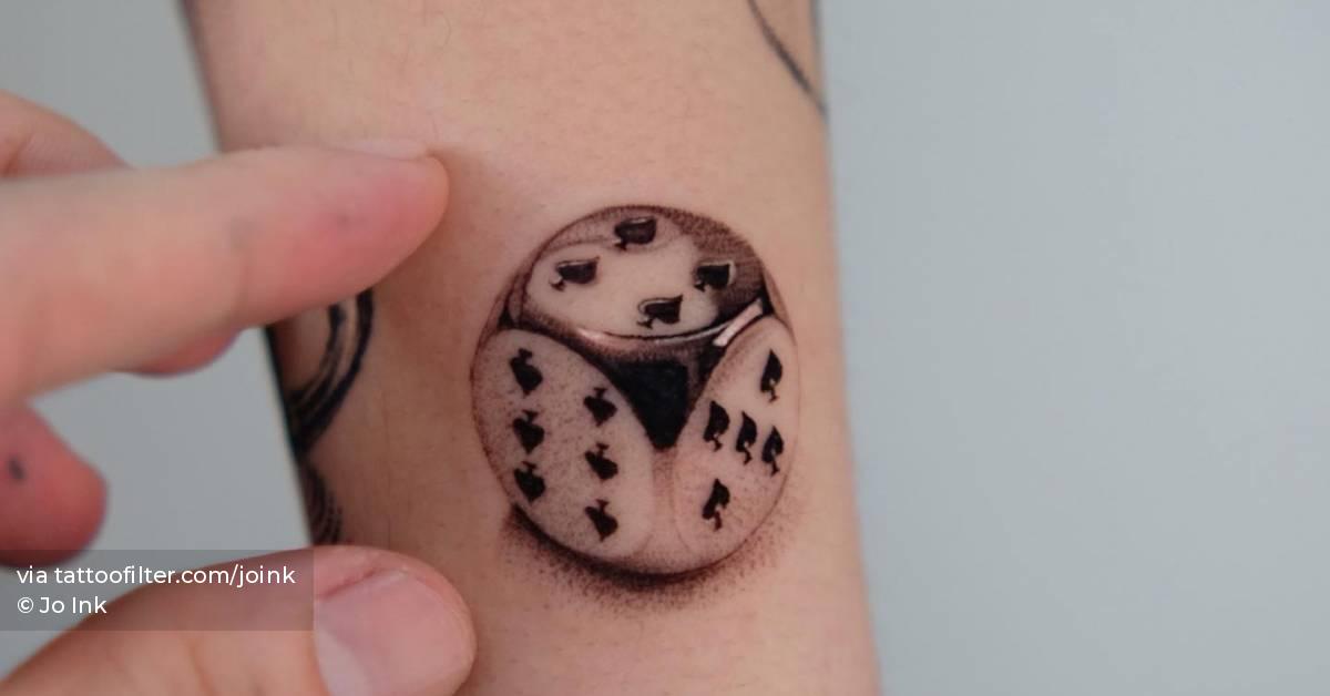Micro-realistic dice tattoo done on the forearm.