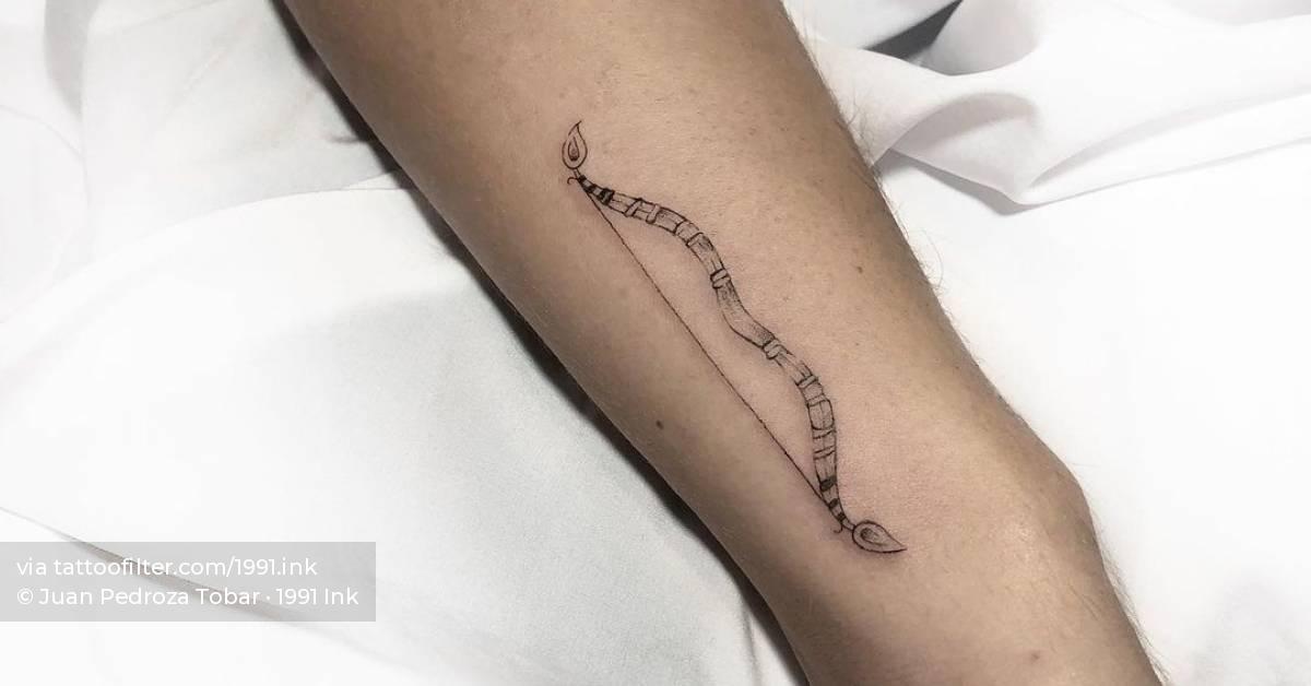 Fine line bow tattoo on the wrist