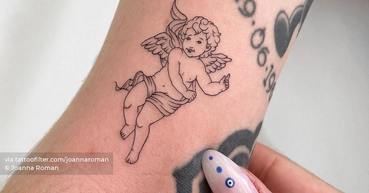 Fine line cherub tattoo done on the bicep.