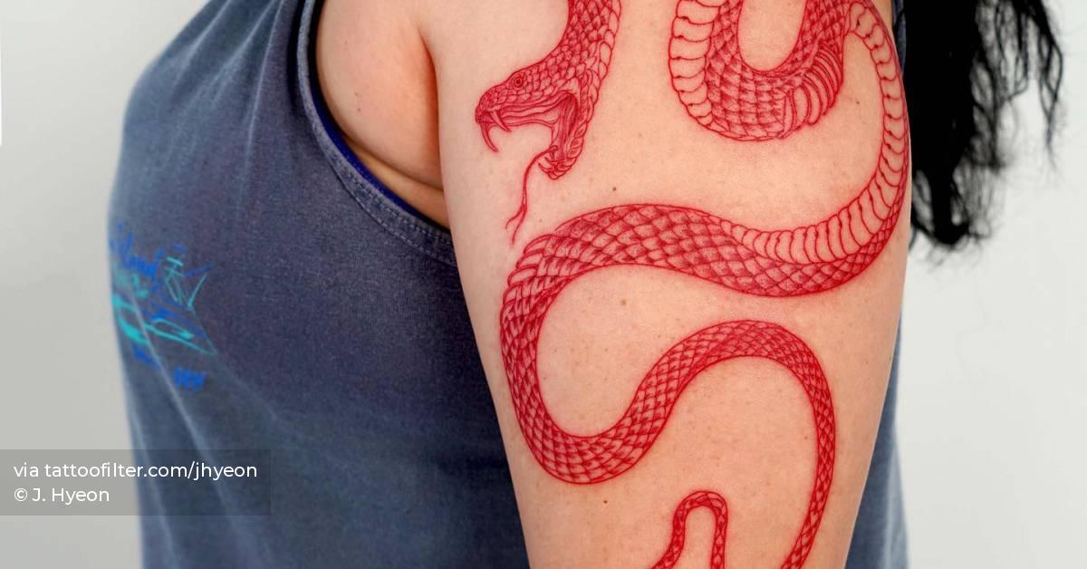 Large red snake tattoo located on the upper arm.