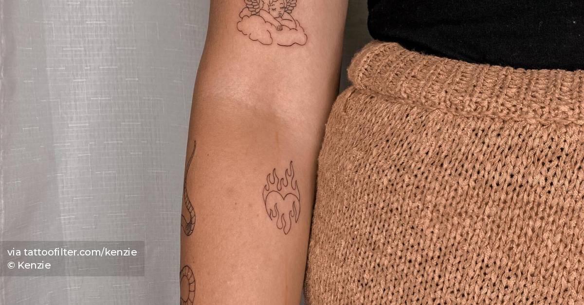 Fine line cherub and flaming heart tattoos located on