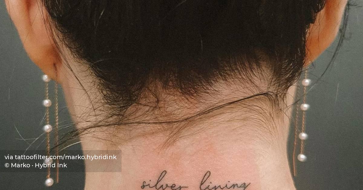 Tattoo that says "silver lining" located on the back of