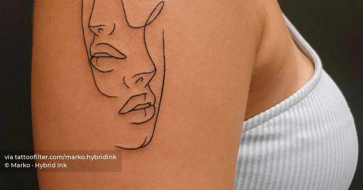 Line art faces tattooed on the upper arm.