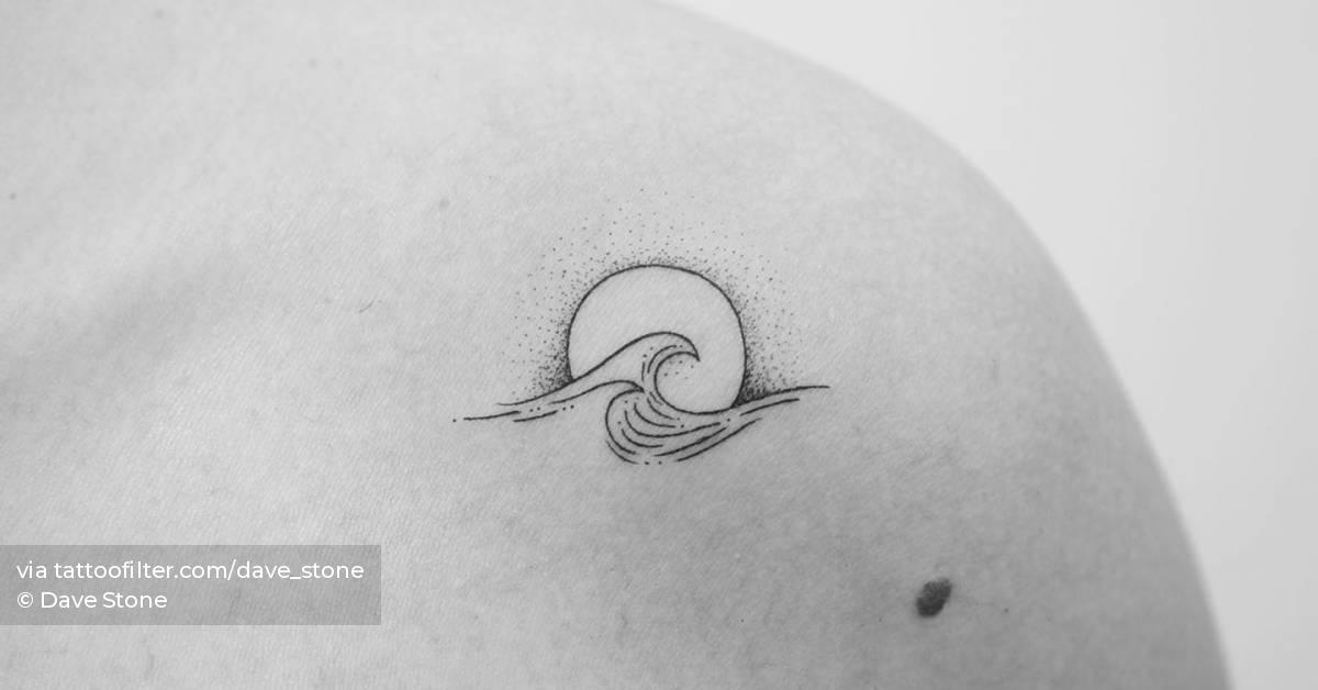 Sun and wave tattoo located on the shoulder.