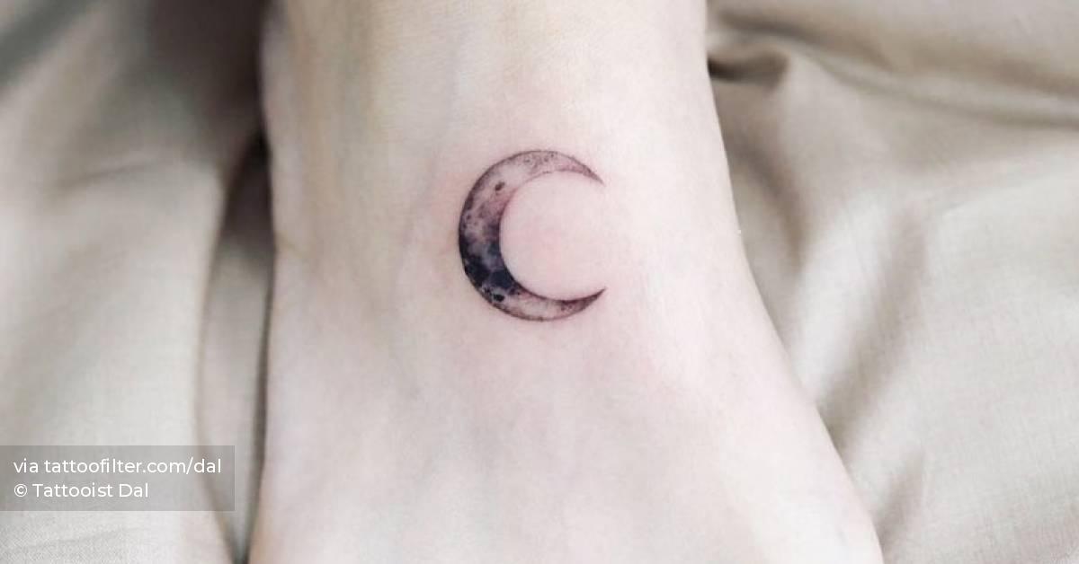 Crescent moon tattooed on the foot, illustrative style.