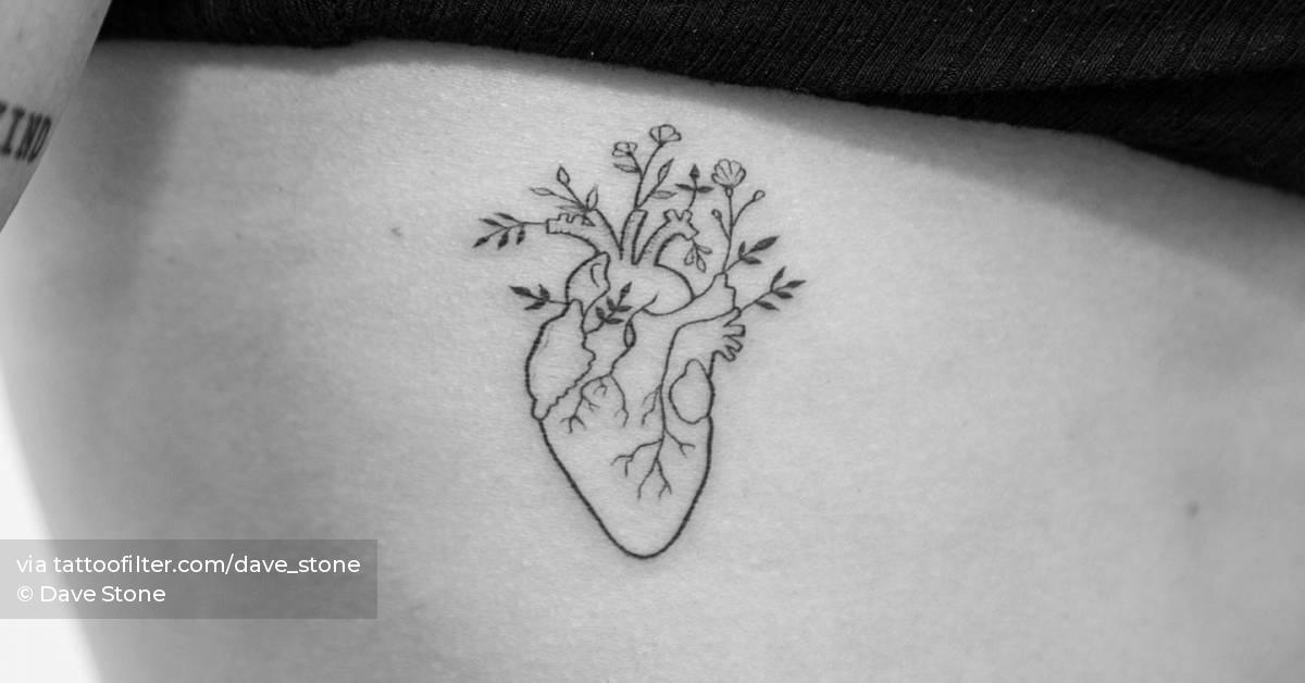 Fine line anatomical heart and flowers tattoo located