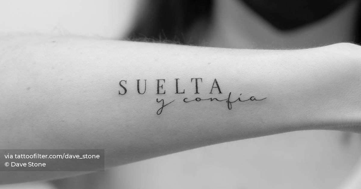 Tattoo that says "suelta y confía" located on the