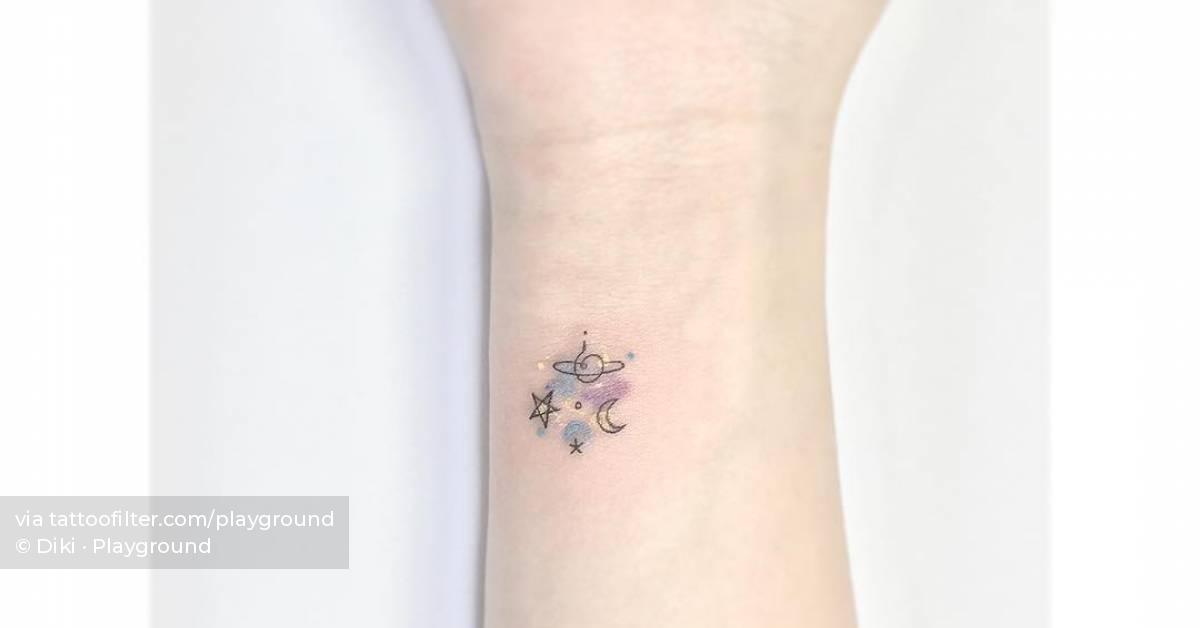 Minimalistic universe tattoo done on the wrist.