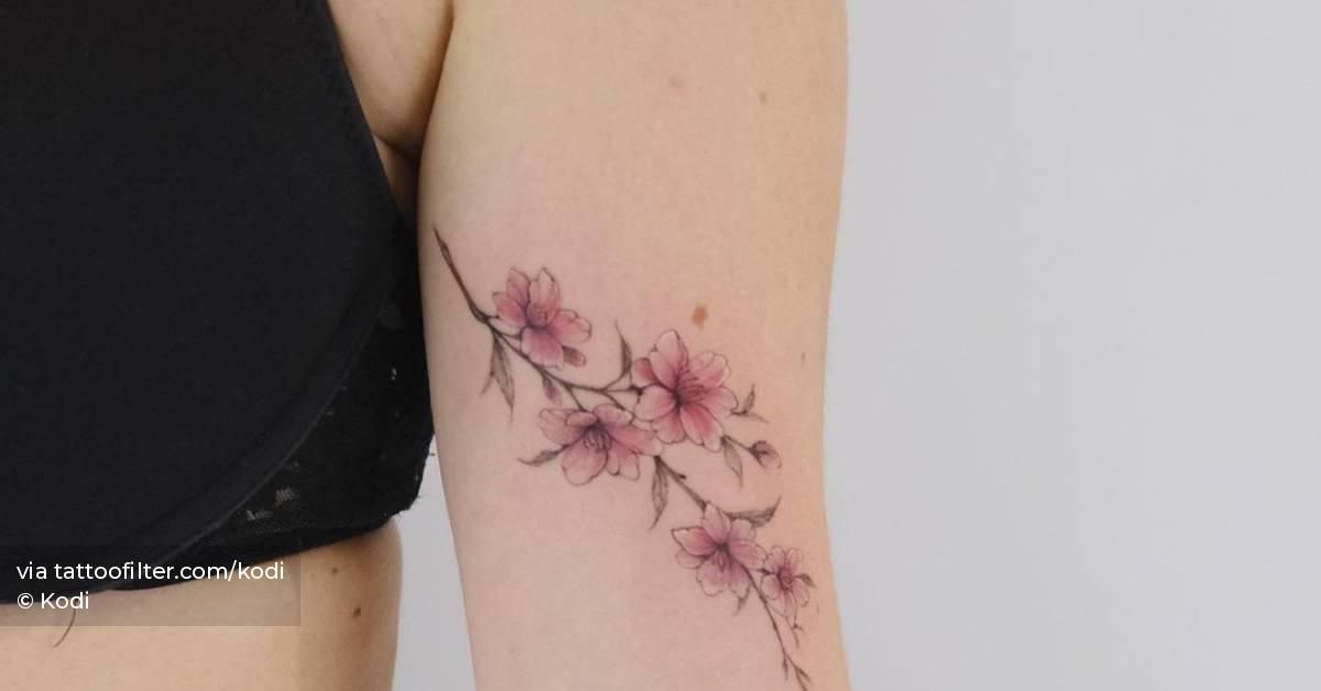 Cherry blossom tattoo located on the inner arm.