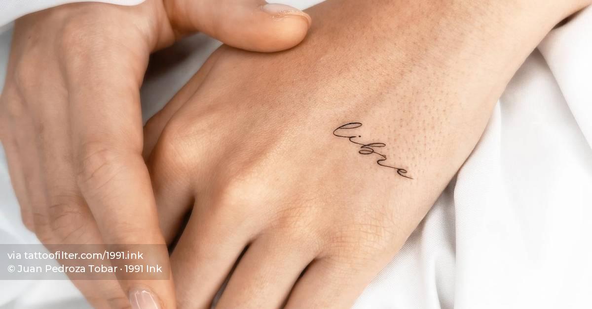 Word "libre" tattooed on the hand.