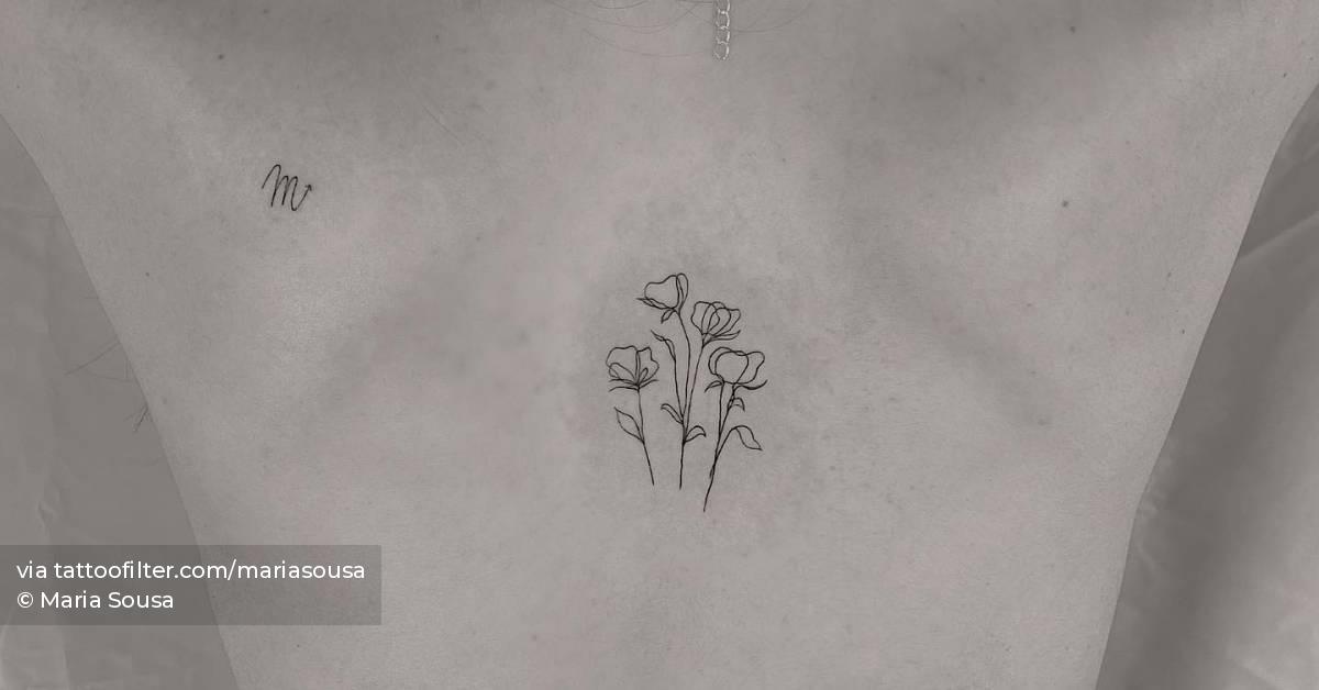 Fine line flowers tattooed on the back.