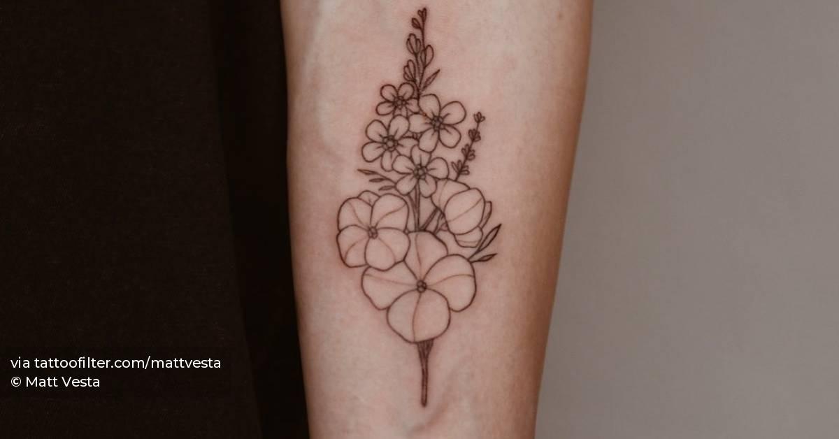 Fine line flowers tattooed on the inner forearm.
