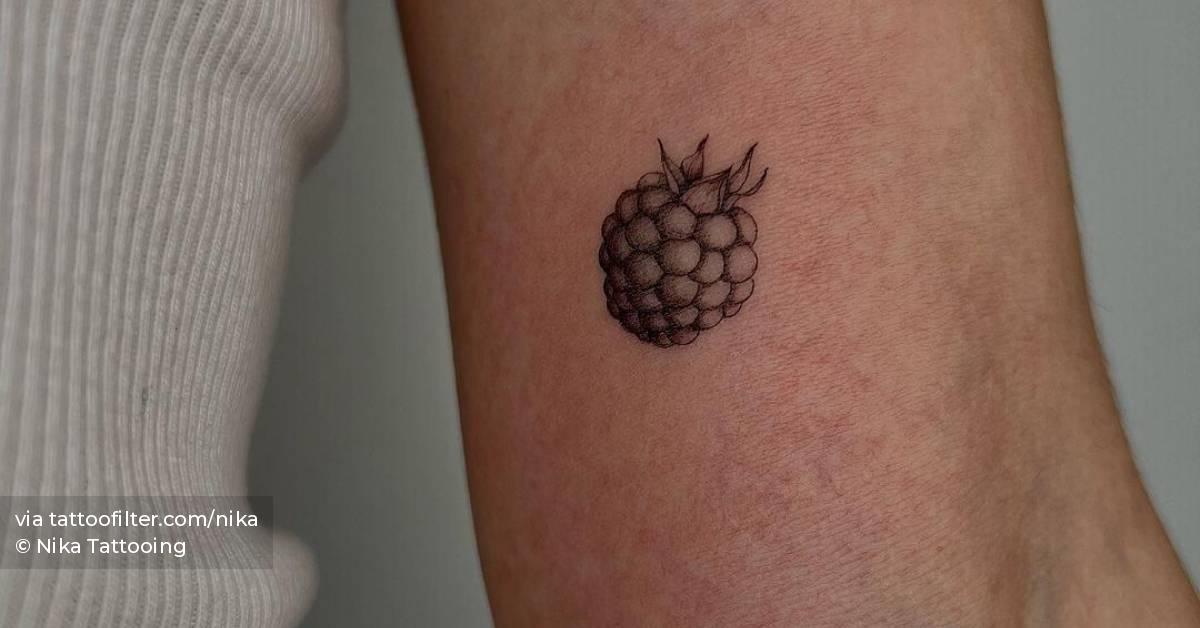 Micro-realistic raspberry tattoo located on the inner