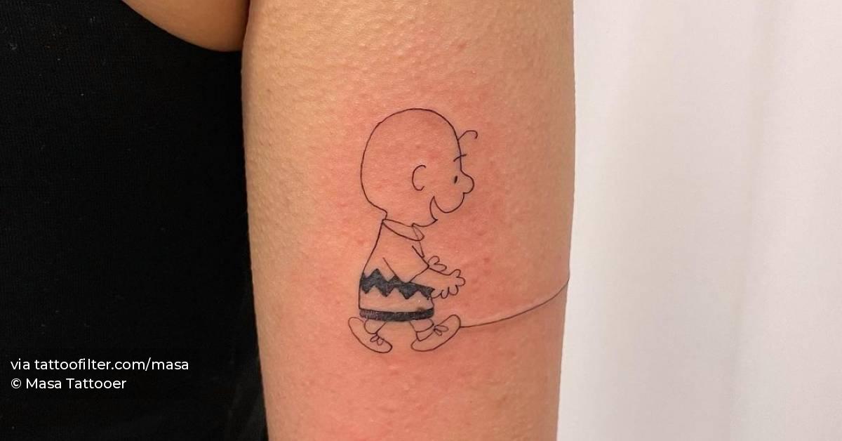 Charlie Brown tattoo located on the tricep.