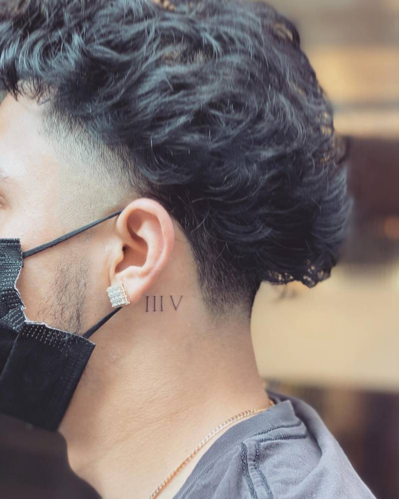 Roman Numerals Tattooed Behind The Ear 