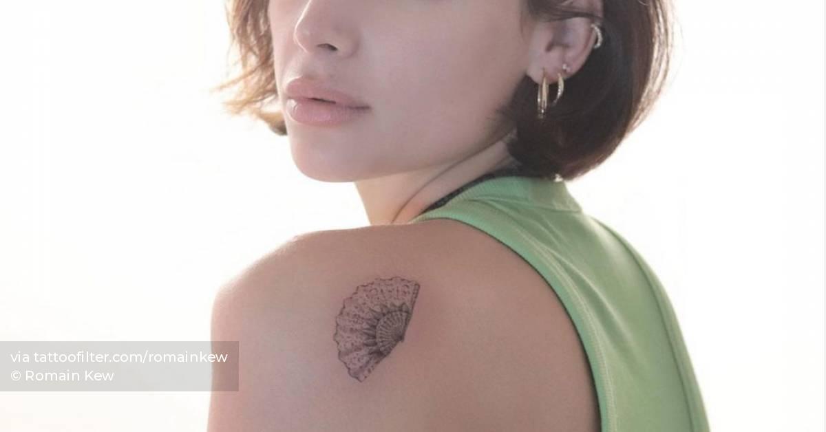 Micro-realistic hand fan tattoo located on Jade