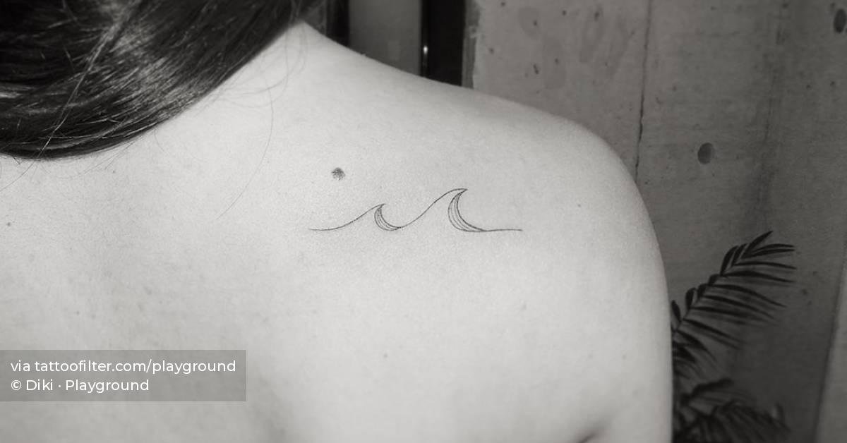 Minimalistic wave tattoo located on the shoulder blade,