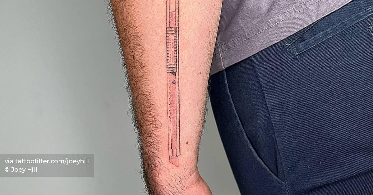 Micro-realistic utility knife tattoo located on the