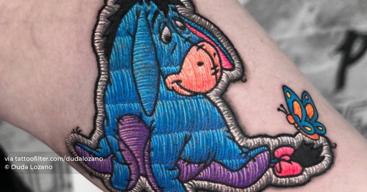 Eeyore patch tattoo located on the inner forearm,
